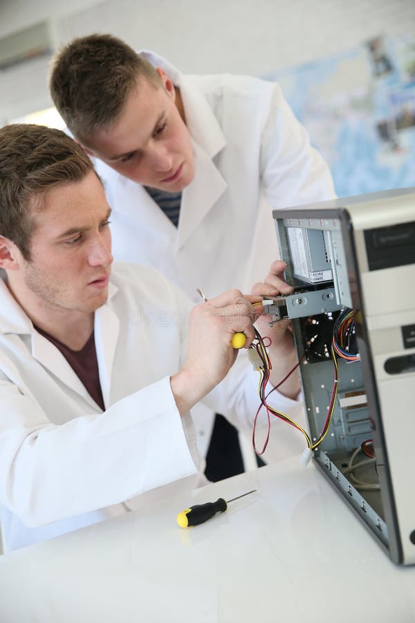Students in Computing Class with Teacher Fixing Computer Stock Photo ...