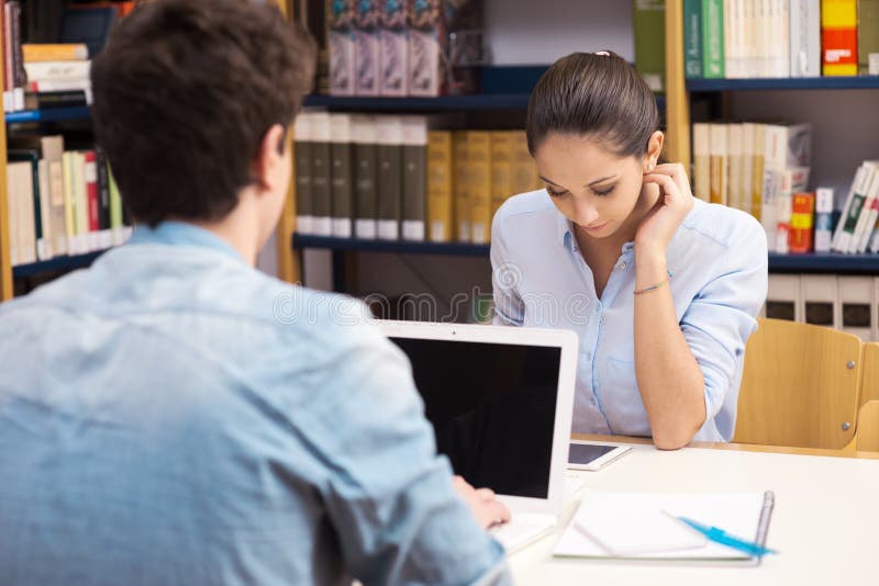 Young students at desk stock image. Image of digital - 53151529