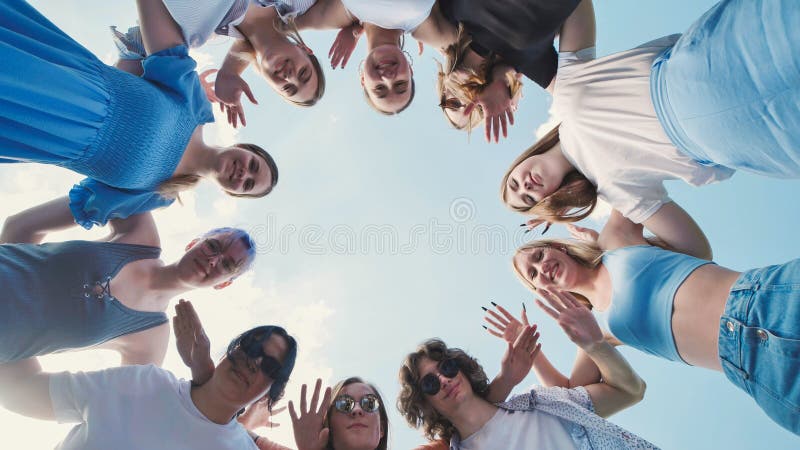 Young Students Gather in a Circle, Waving at the Camera with a Vibrant ...