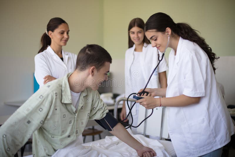Students in Hospital Measures the Patient`s Pressure Stock Photo ...