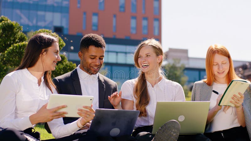 Young Students Multiracial Doing Homework in Group they Using Laptops ... Young Students Multiracial Doing Homework in Group they Using Laptops ...