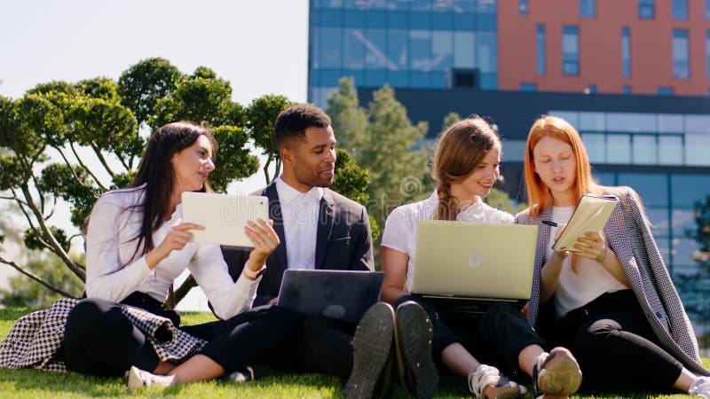 Young Students Multiracial Doing Homework in Group they Using Laptops ... Young Students Multiracial Doing Homework in Group they Using Laptops ...