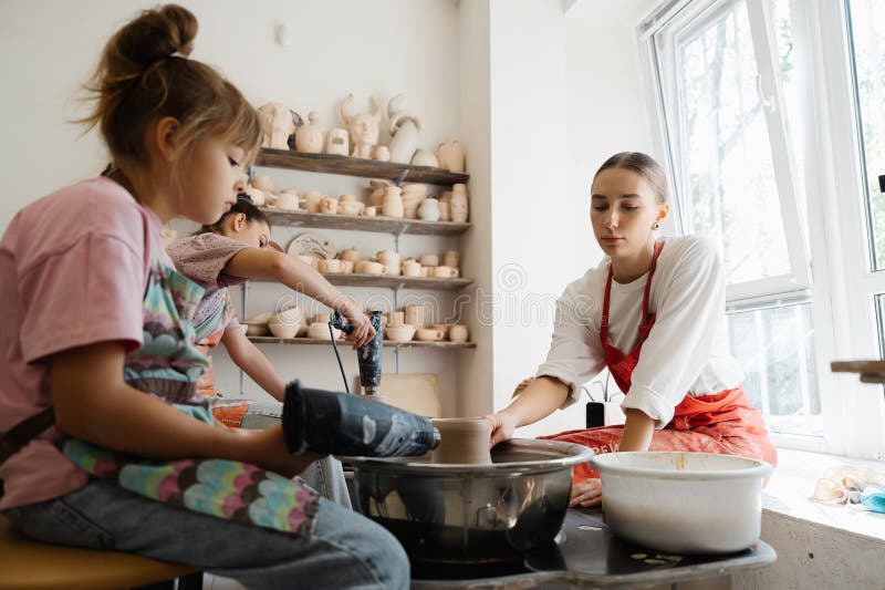Children Learning Pottery Skills in a Bright Workshop during the ...
