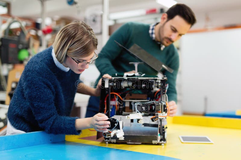 Young Students of Robotics Preparing Robot for Testing Stock Photo ...
