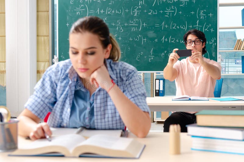 The Young Students Taking the Math Exam in Classroom Stock Photo ...