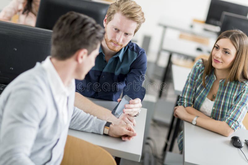 Young Students Talking in a Classroom Stock Image - Image of male ...