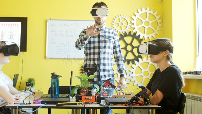 Young Students and Teacher with Robot in Classroom Stock Image - Image ...
