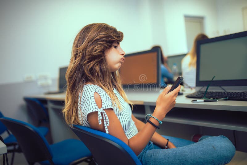Young Students Using Phone in a Computer Lab Stock Image - Image of ...
