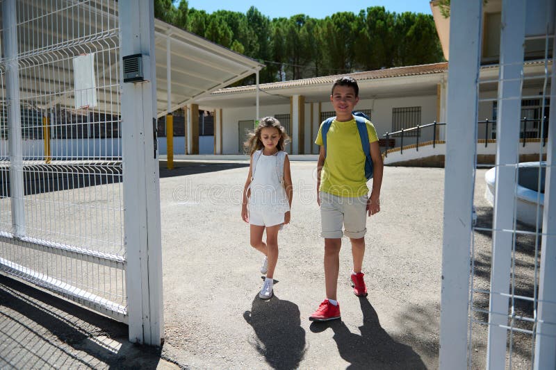 Young Students Walking through School Gates on a Sunny Day Stock Photo ...