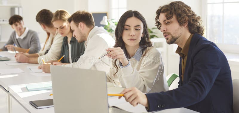 Young Students Collaborating in Modern Classroom, Discussing Project ...