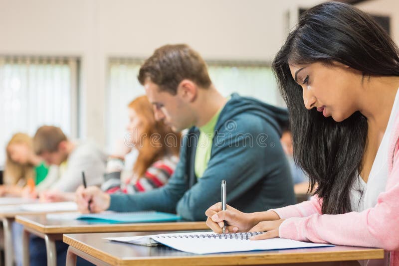 Young Students Writing Notes in Classroom Stock Image - Image of school ...