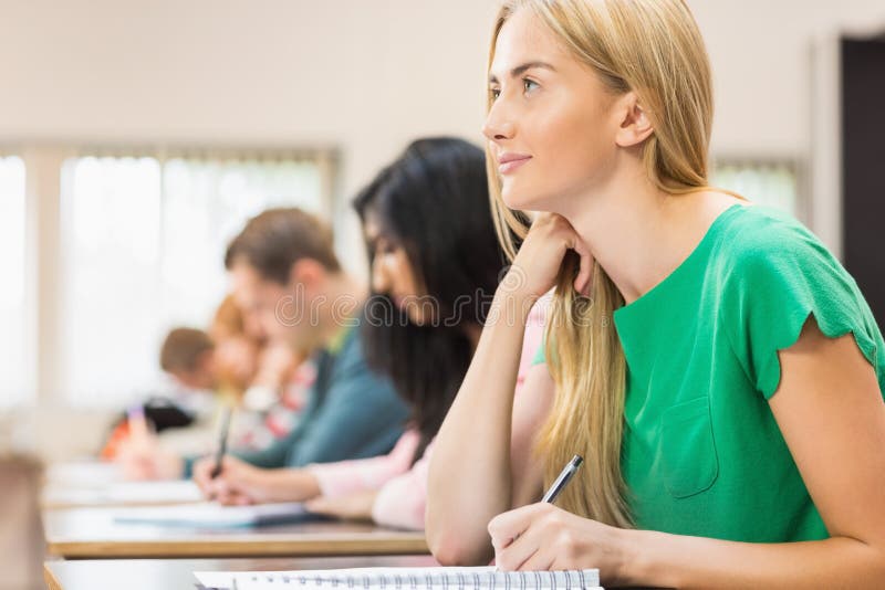 Young Students Writing Notes in Classroom Stock Photo - Image of ...