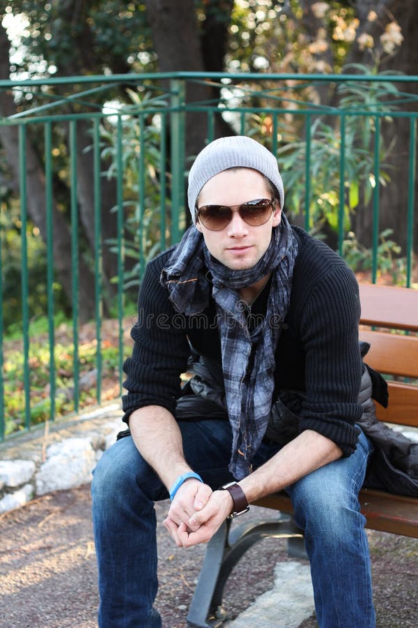 Young Stylish Man Sitting on a Bench Stock Image - Image of looking ...