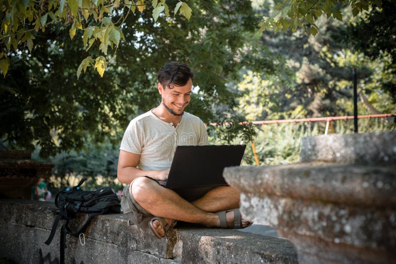 Young Stylish Man Using Notebook Stock Photo - Image of smiling, young ...