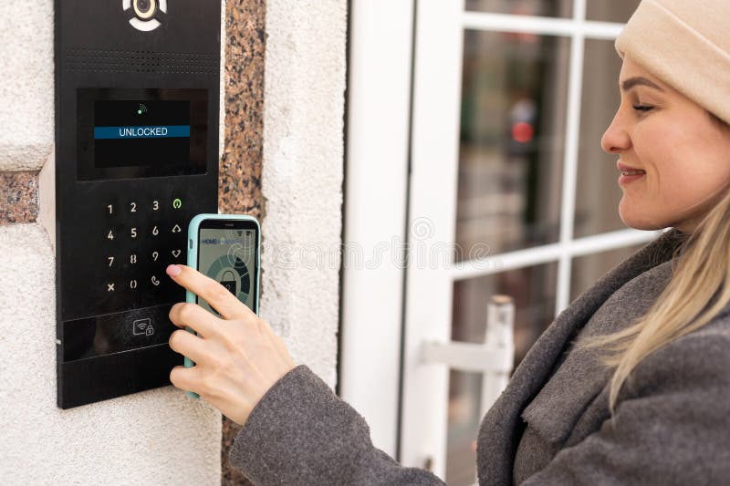 Young Stylish Woman Getting Access To the Building by Attaching ...