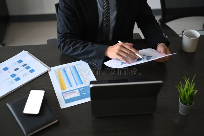 A Businessman Analyzes Financial Document Ad Working with Computer ...