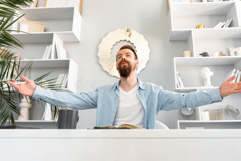 Young Successful Man Sitting at the Table Raising His Hands Stock Image ...