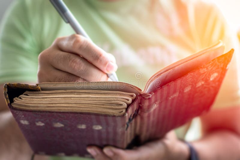 A Young Successful Person Taking Notes in a Personal Journal Stock ...