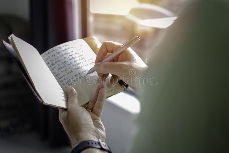 A Young Successful Person Taking Notes in a Personal Journal Stock ...