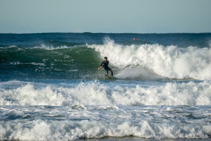 Young Surfer Catching Waves before Work on an Early Friday Morning at ...