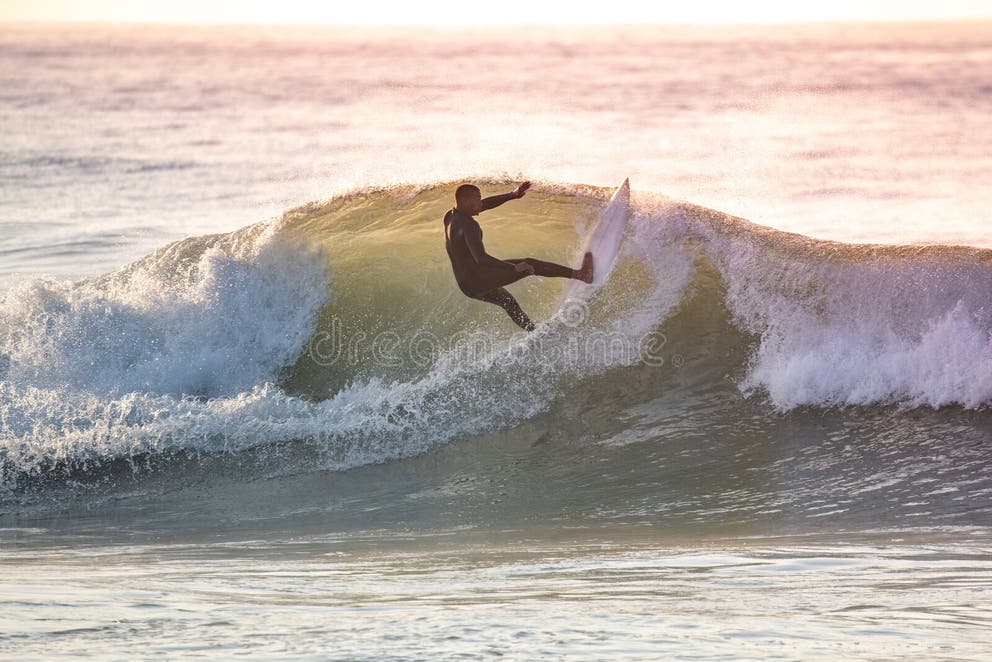 Young Surfer Enjoying Waves Stock Photo - Image of silhouette, beach ...