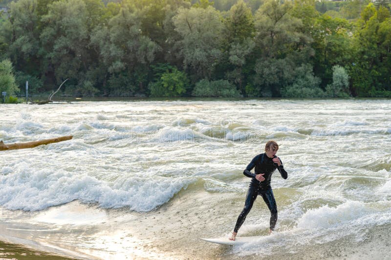 A Young Surfer Surfs in the Aare River during High Tide Stock Photo ...