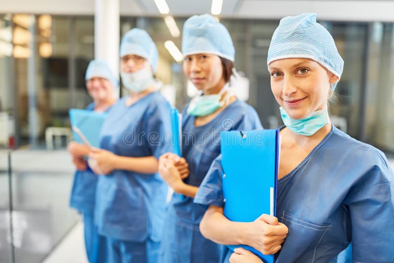 Young Surgeon in Training with Team Stock Image - Image of female ...