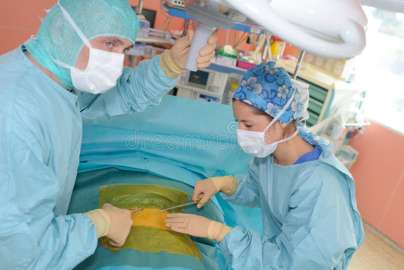 Young Surgery Team in Operating Room Stock Photo - Image of operating ...