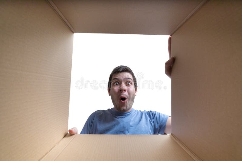 Young Man Surprised Opening Box and Looking Inside and Unpacking the ...