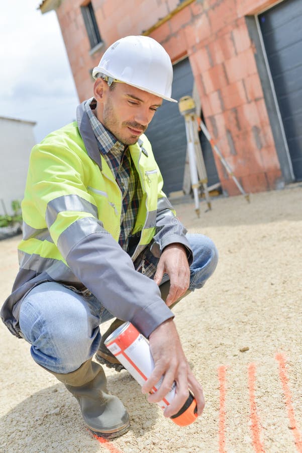 Young Surveyor Spraying Mark on Floor Stock Image - Image of total ...