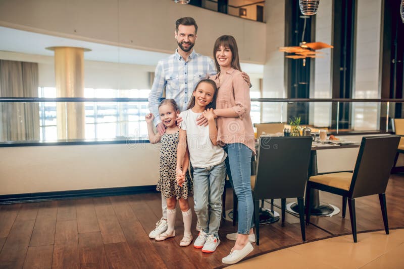 Young Sweet Family Standing and Looking Happy Stock Photo - Image of ...