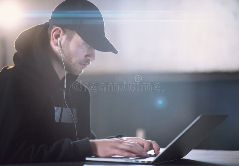 Young Talented Hacker Using Laptop Computer while Working in Dark ...