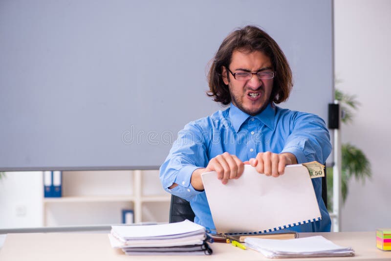 Young Male Teacher in the Classroom Stock Photo - Image of cash ...