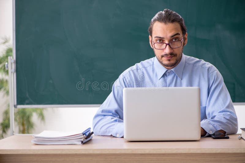 Young Male Teacher in the Classroom in Tele-education Concept Stock ...