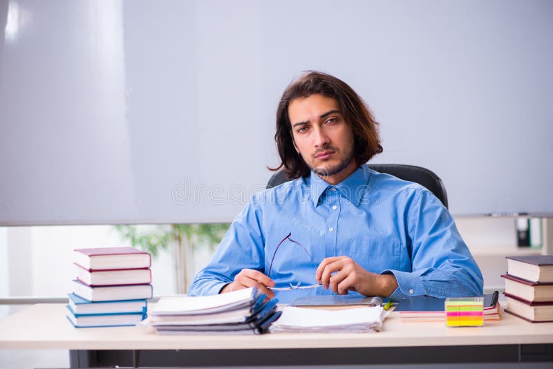 Young Male Teacher in the Classroom Stock Image - Image of explaining ...