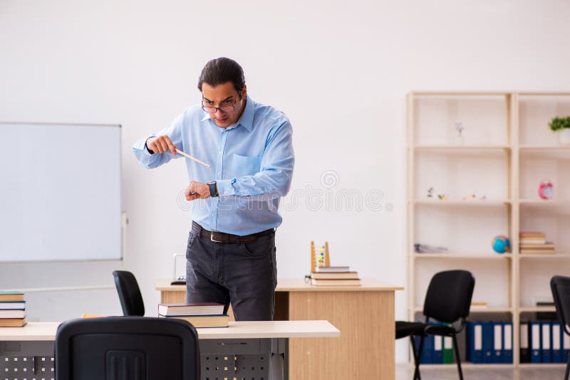 Young Male Teacher in the Classroom Stock Image - Image of book ...