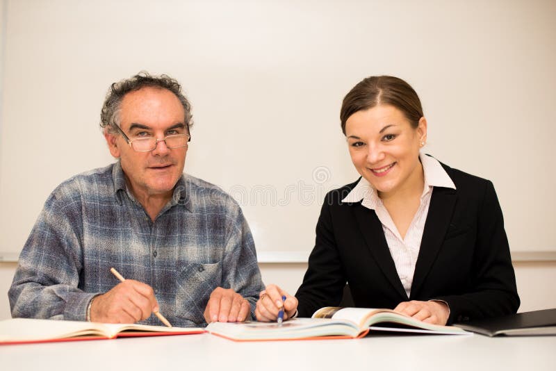 Young Teacher Explaining Somethng To Eldery Man. Intergenerational ...