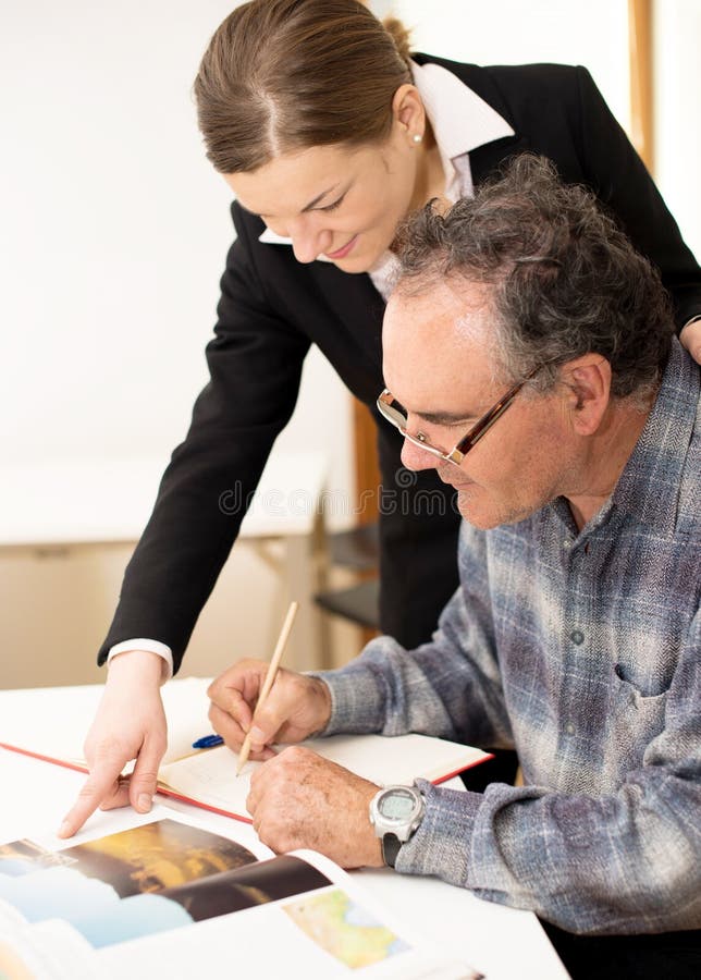 Young Teacher Explaining Somethng To Eldery Man. Intergenerational ...