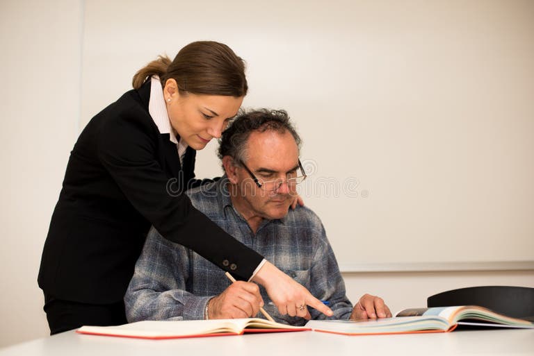 Young Teacher Explaining Somethng To Eldery Man. Intergenerational ...
