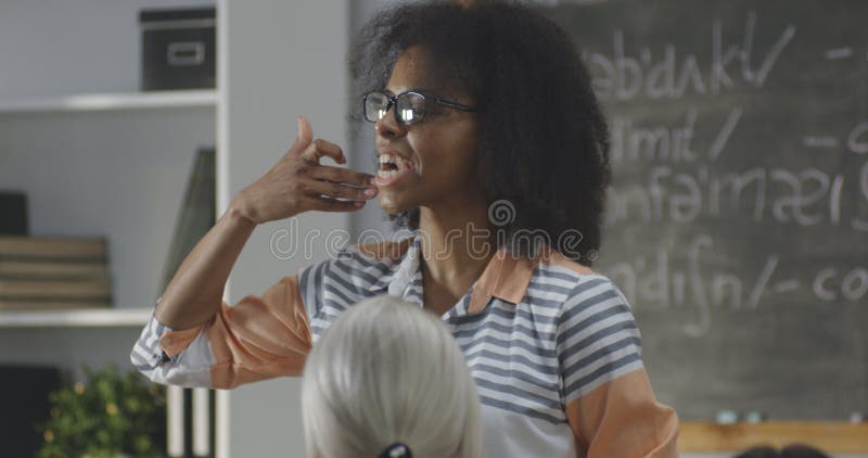 Young Teacher Explaining To a Class Stock Photo - Image of teaching ...