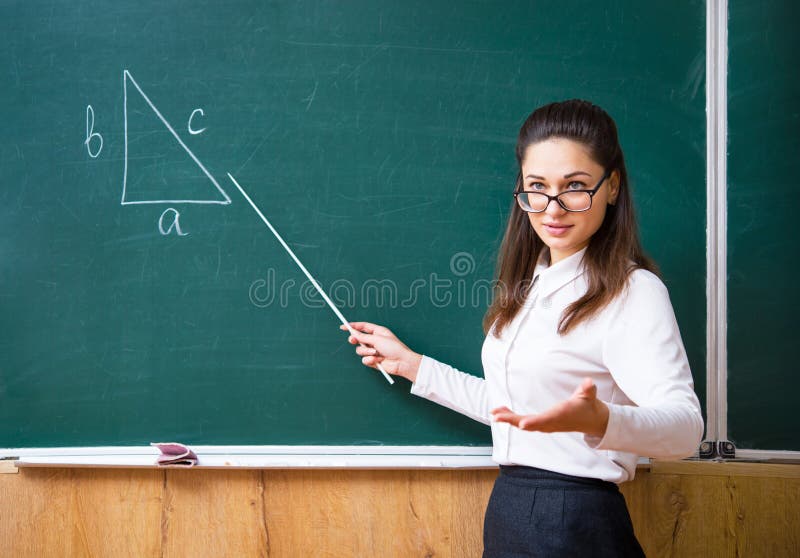 A Young Teacher Explains Math Near the Board Stock Image - Image of ...
