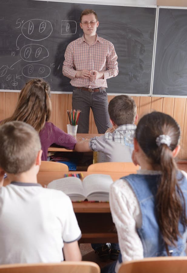 Young Teacher in Front of Class Stock Photo - Image of schoolboy ...
