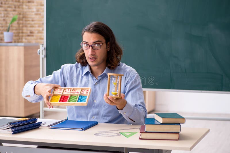 Young Male Teacher in Front of Green Board Stock Image - Image of ...