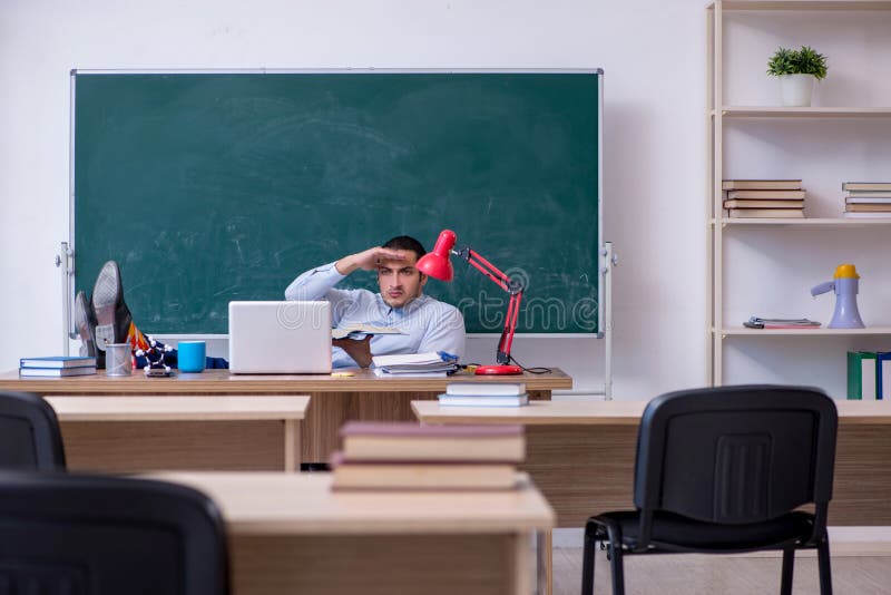 Young Male Teacher in Front of Green Board Stock Photo - Image of ...
