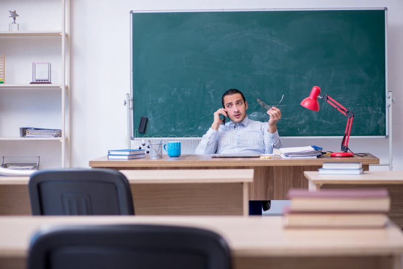 Young Male Teacher in Front of Green Board Stock Image - Image of ...