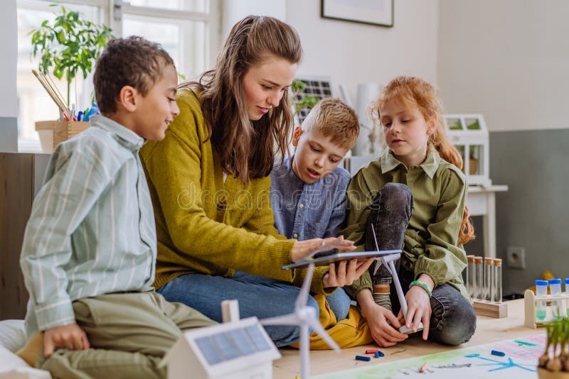 Young Teacher Learning Pupils about Solar and Wind Energy. Stock Photo ...