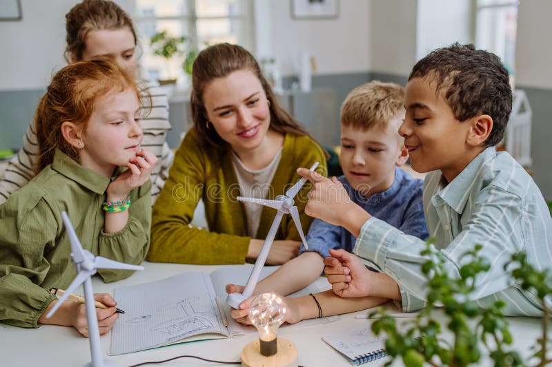 Young Teacher with Model of Wind Turbine Learning Pupils about Wind ...