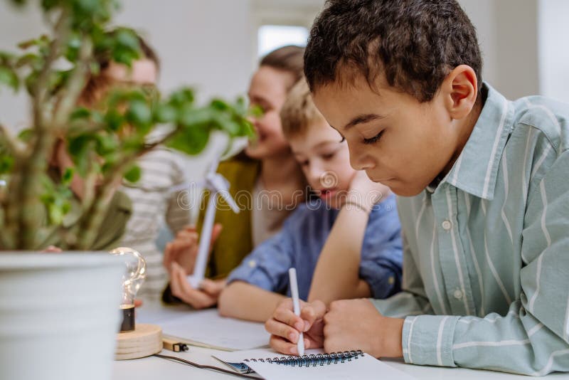 Young Teacher with Model of Wind Turbine Learning Pupils about Wind ...