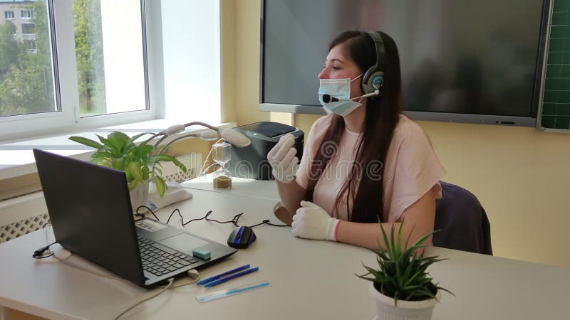 A Young Teacher Ridiculously Pulls Off a Mask on Her Face. Stock Video ...