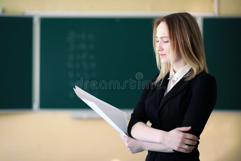 Young Teacher in School Class Stock Image - Image of math, classmates ...